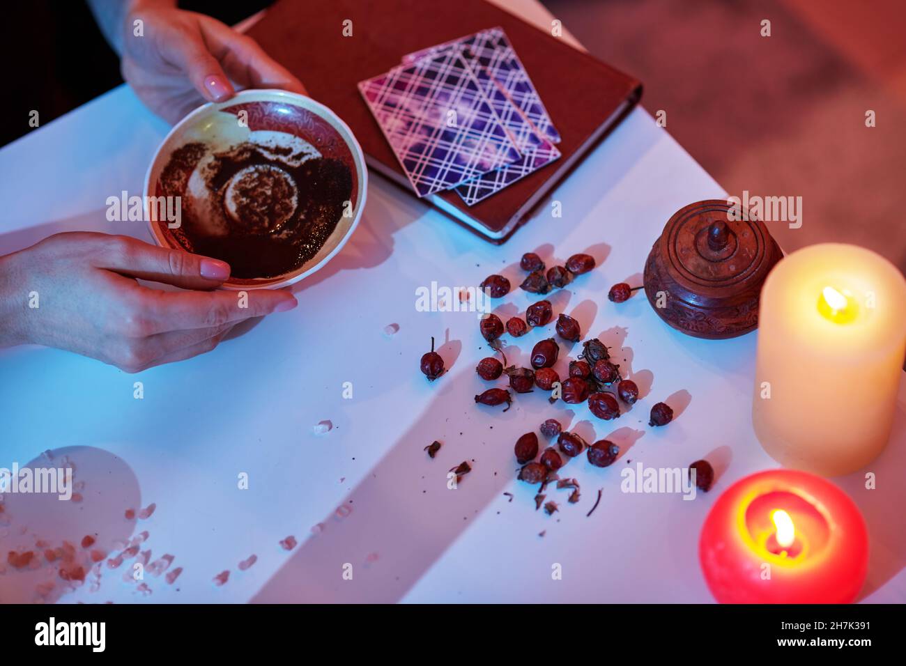 Experienced coffee reader predicting her future during the tasseography ...