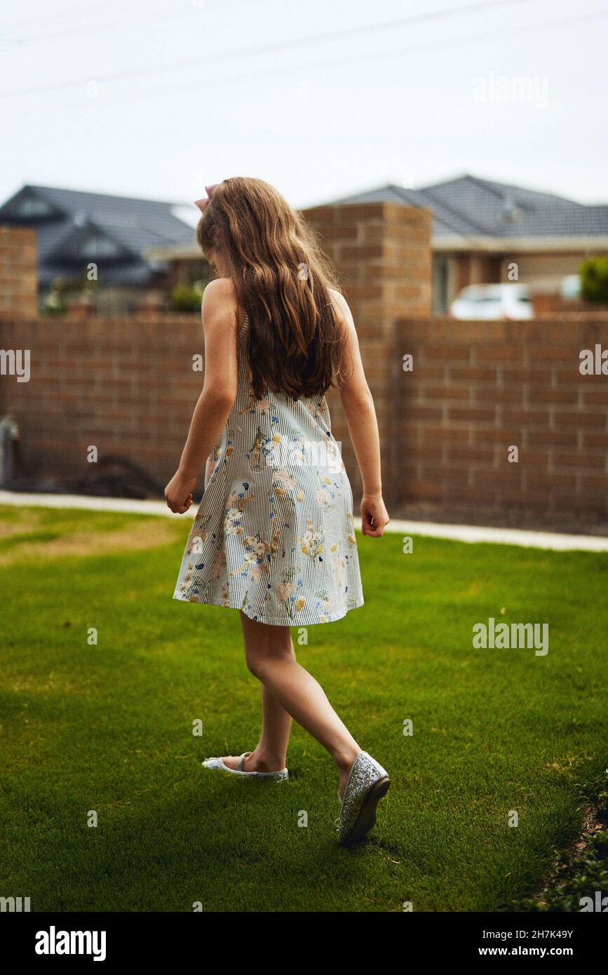 Girl walking on lawn Stock Photo - Alamy