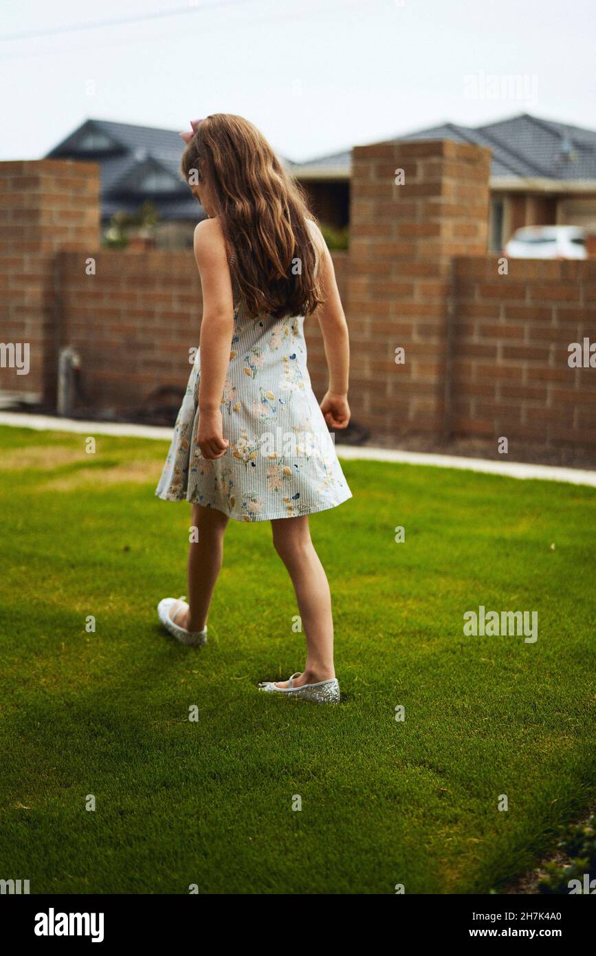 Girl walking on lawn Stock Photo - Alamy