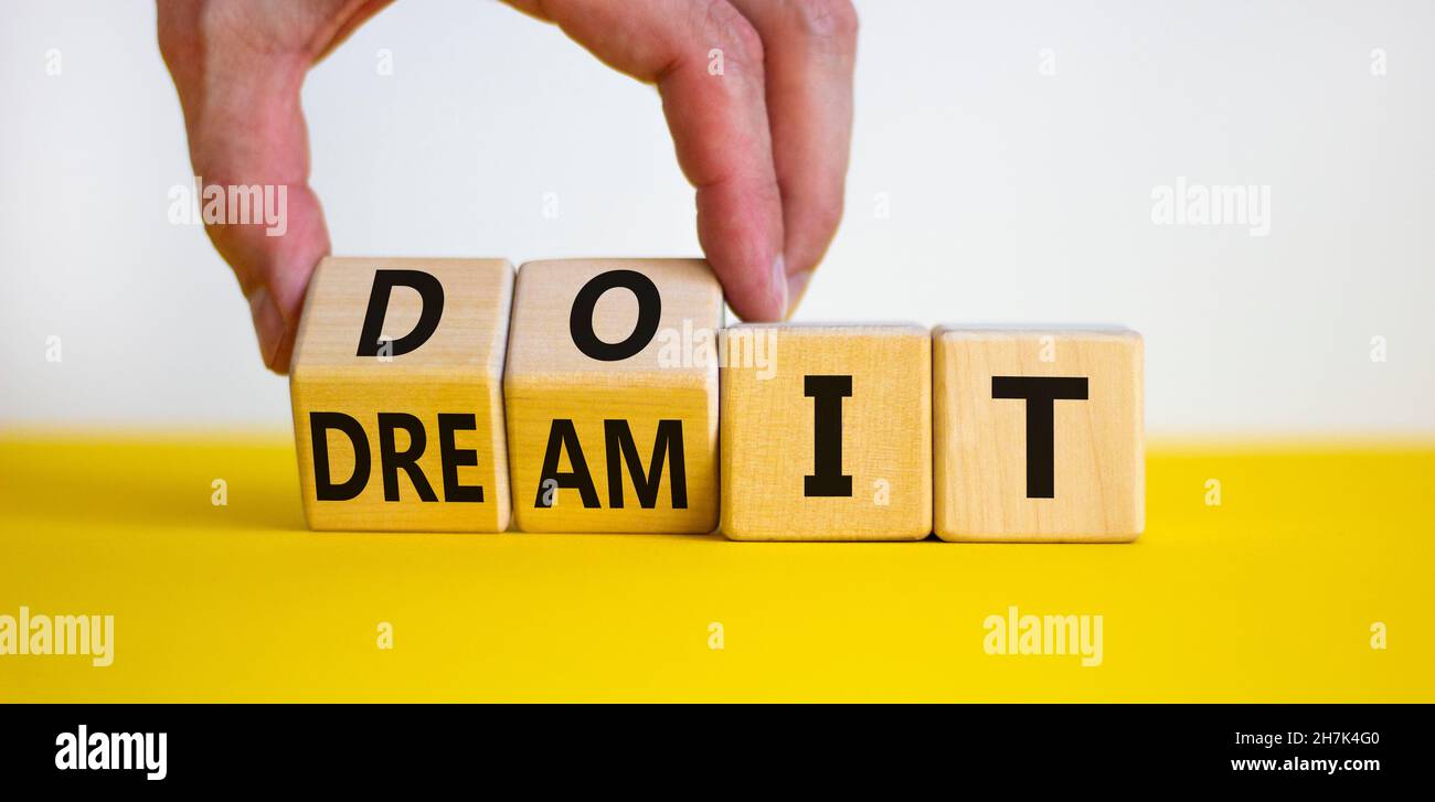 Dream and do it symbol. Businessman turns cubes and changes words ...