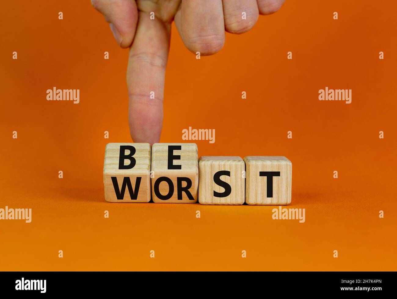 Best or worst symbol. Businessman turns wooden cubes and changes the ...