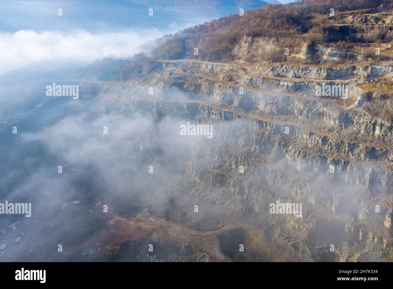 Landscape morning fog on mountain with quarry extracting stone mine ...