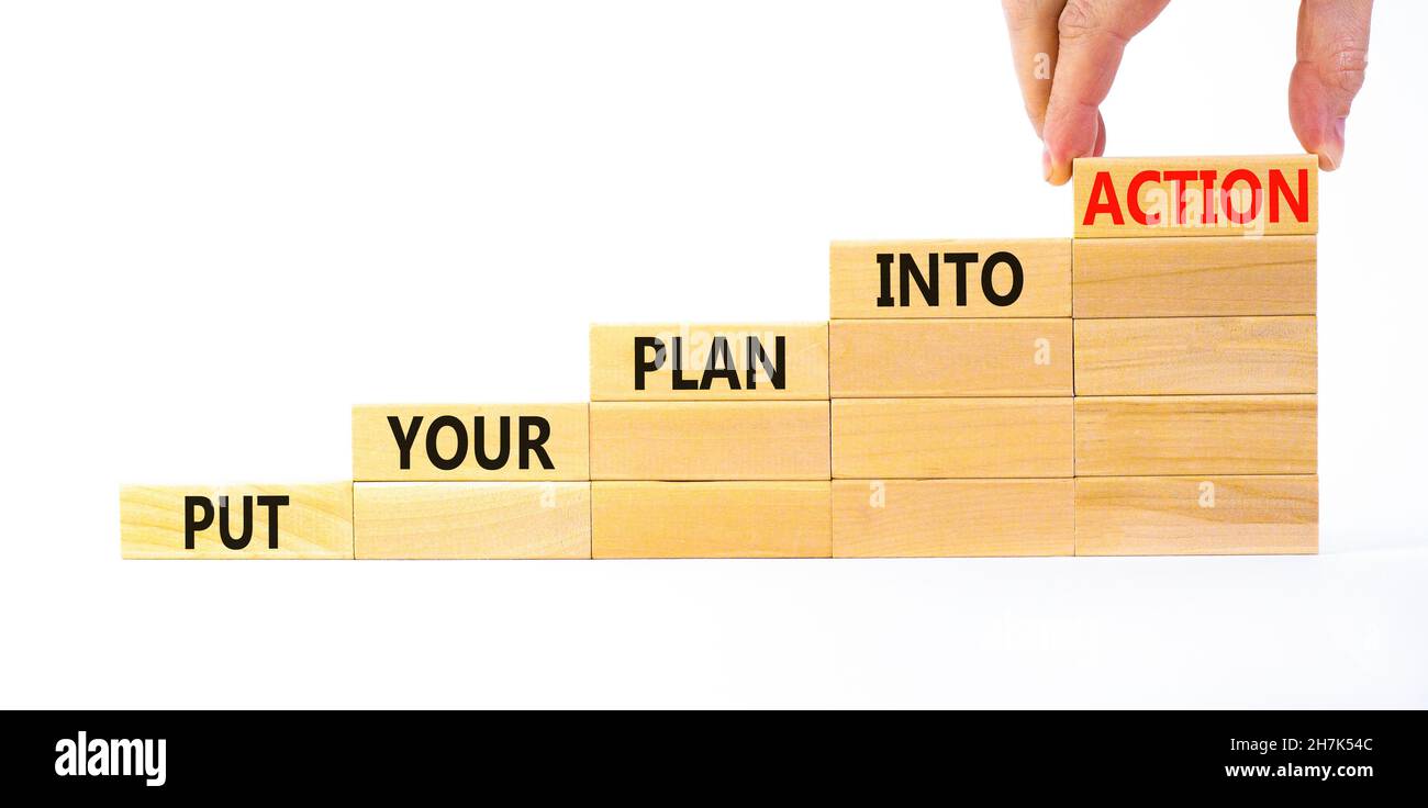 Put your plan into action symbol. Wooden blocks with words Put your ...