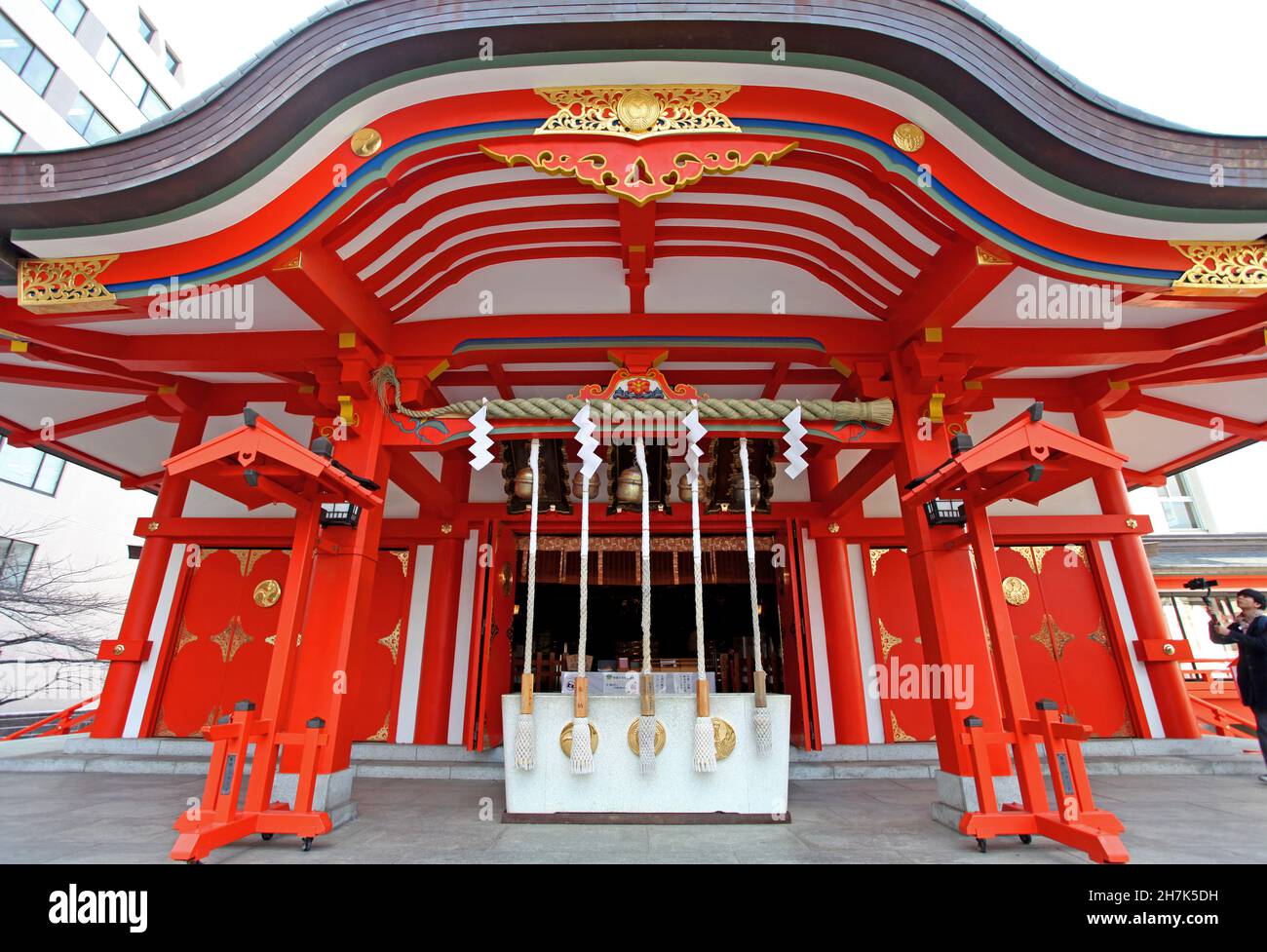 The Hanazono Shrine with vermilion colored buildings and torii gates in ...