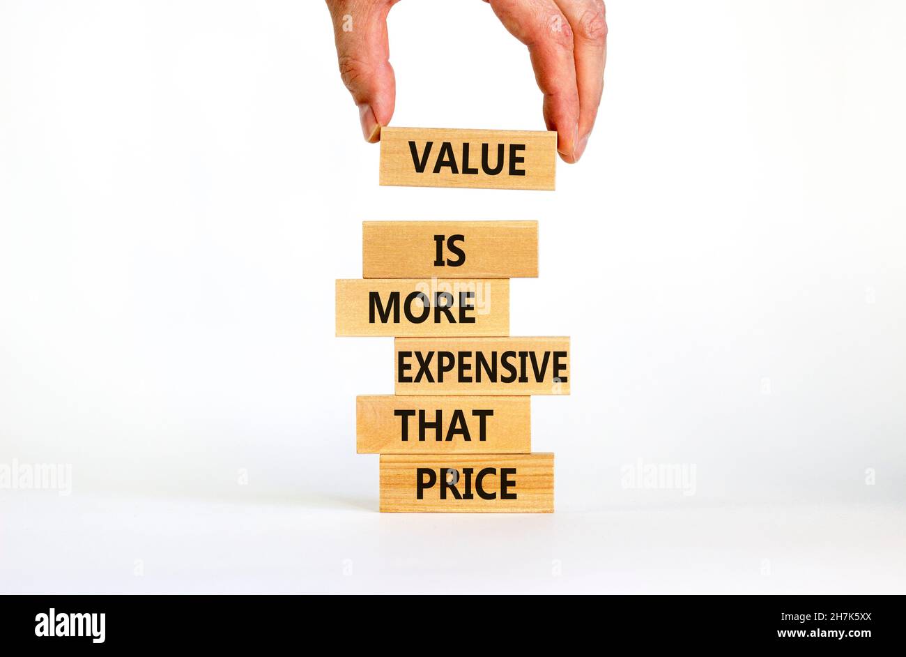 Price or value symbol. Wooden blocks with concept words Value is more ...