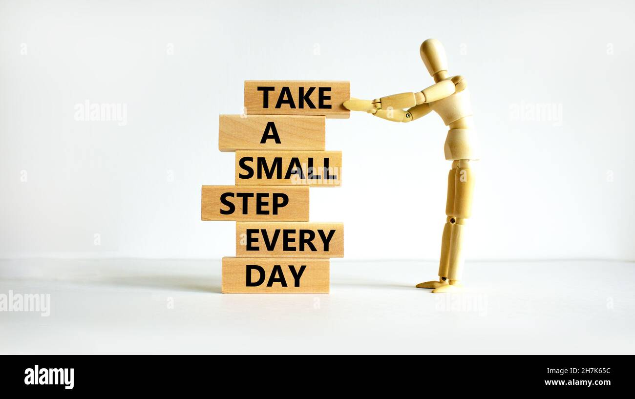 Take a small step every day symbol. Wooden blocks with words Take a ...