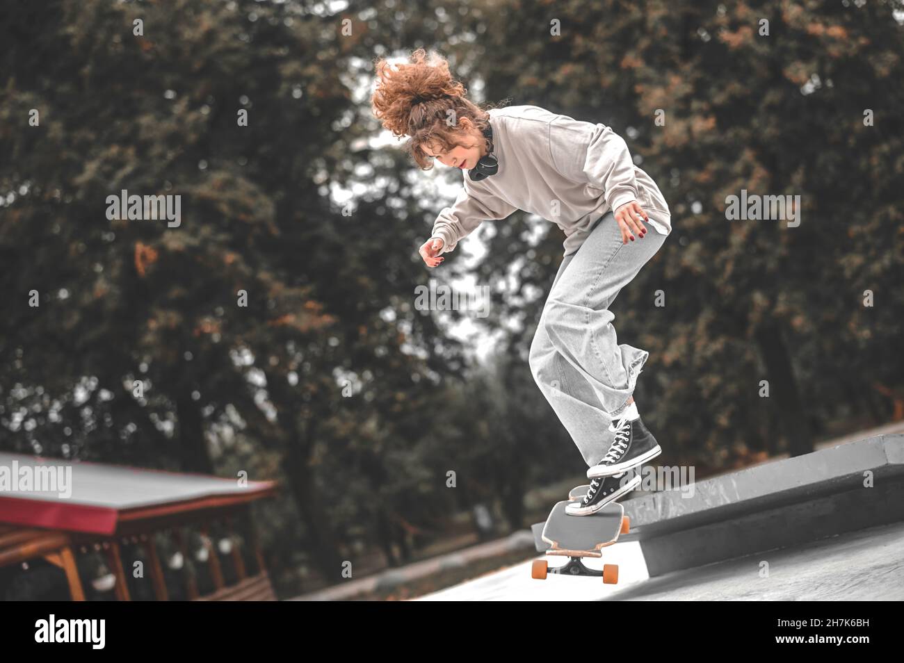 Girl on skateboard at moment of jumping from springboard Stock Photo ...