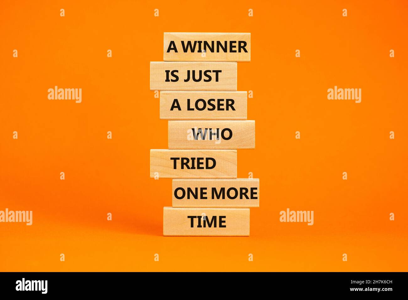Winner or loser symbol. Wooden blocks with words A winner is just a ...