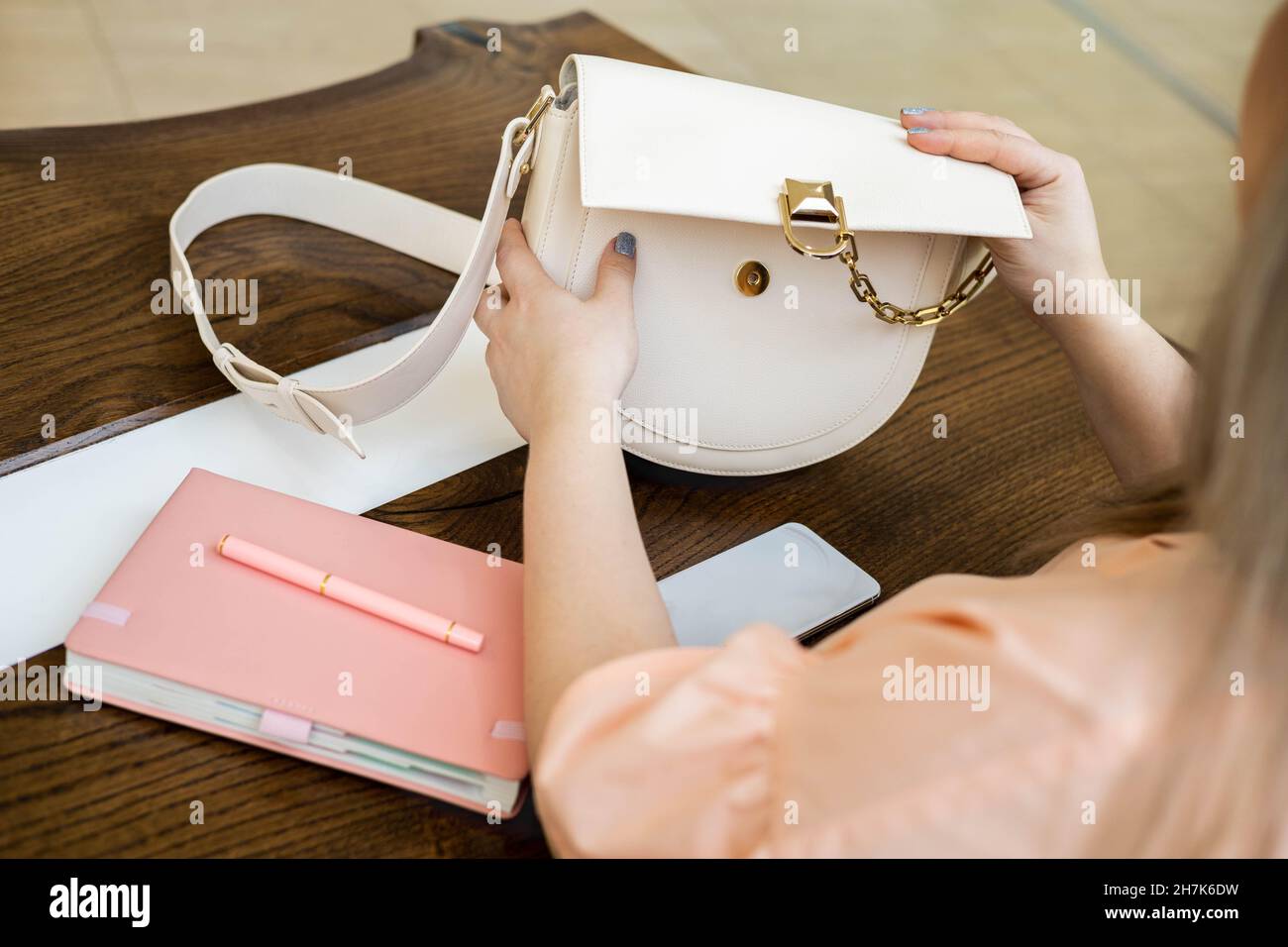 Top view business female hands pulling out pink notepad diary pen ready ...