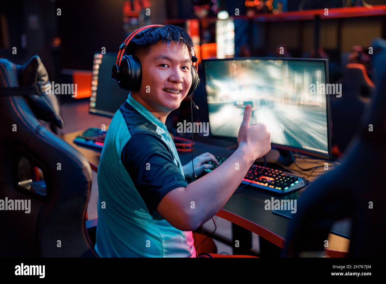 Asian gamer happy with his game in cyber club Stock Photo - Alamy