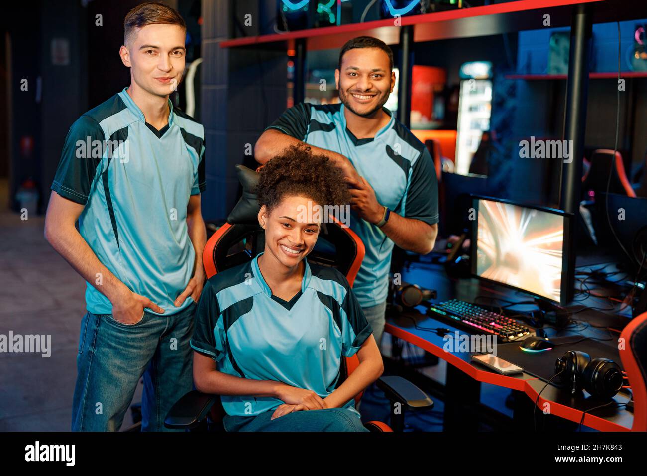 Young multiethnic gamers posing at camera in cyber club Stock Photo - Alamy