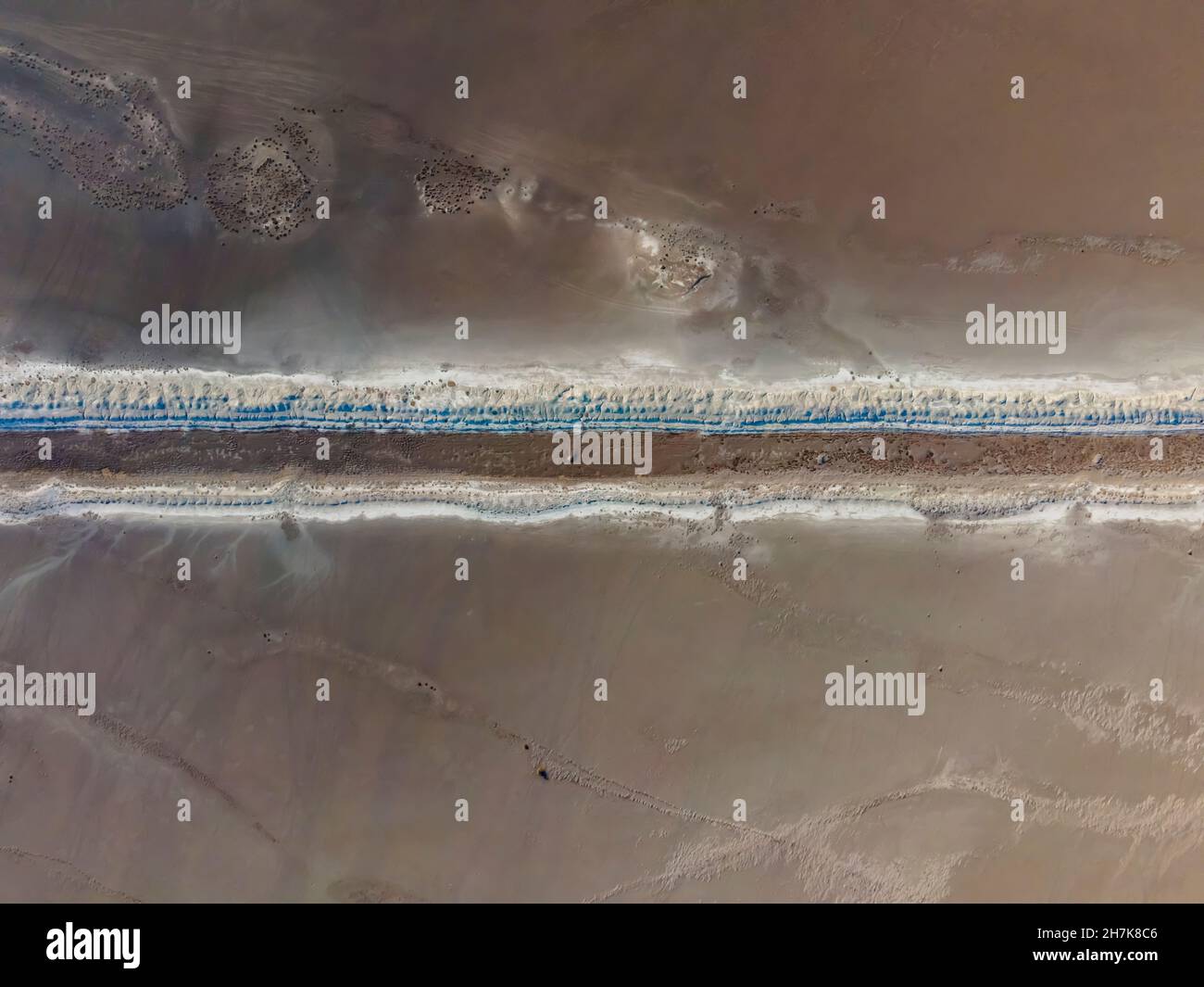 Aerial view of a dried-up riverbed and a Death Valley field as a result ...
