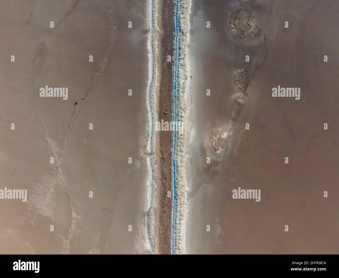 Aerial view of a dried-up riverbed and a Death Valley field as a result ...