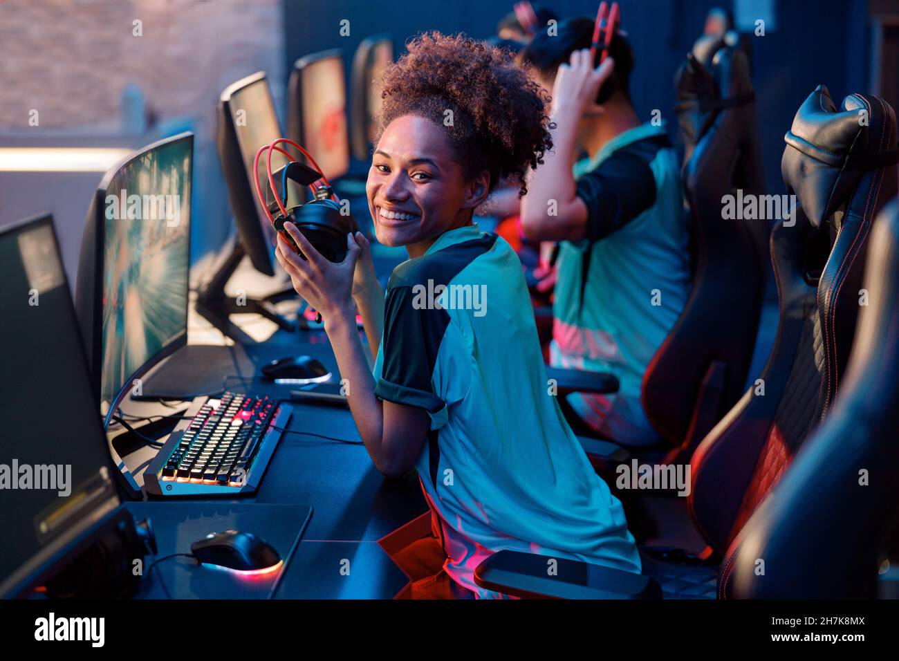 Cute woman gamer getting ready for game in computer club Stock Photo ...