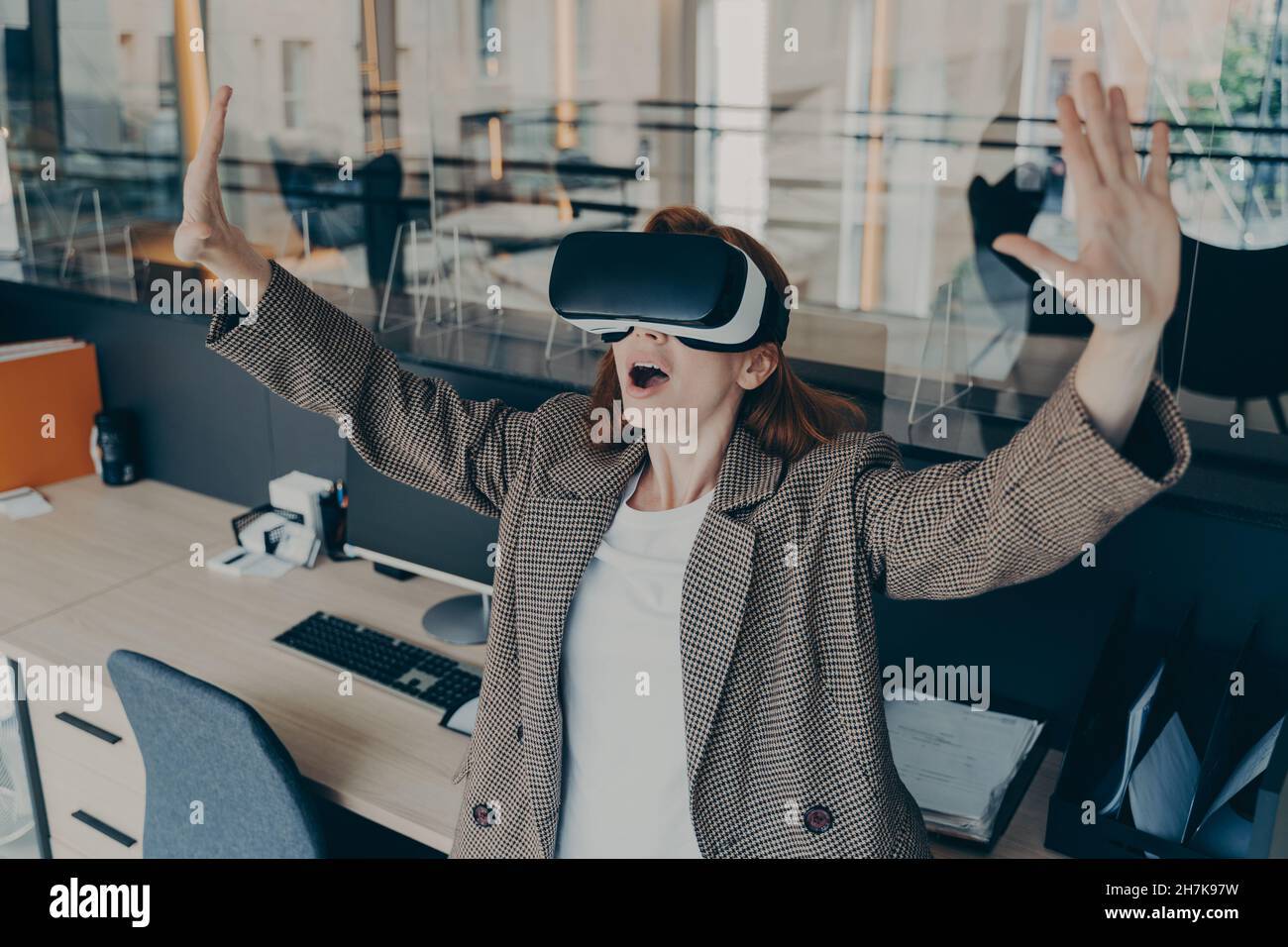 Woman seeing something huge and unbelievable in virtual reality while ...