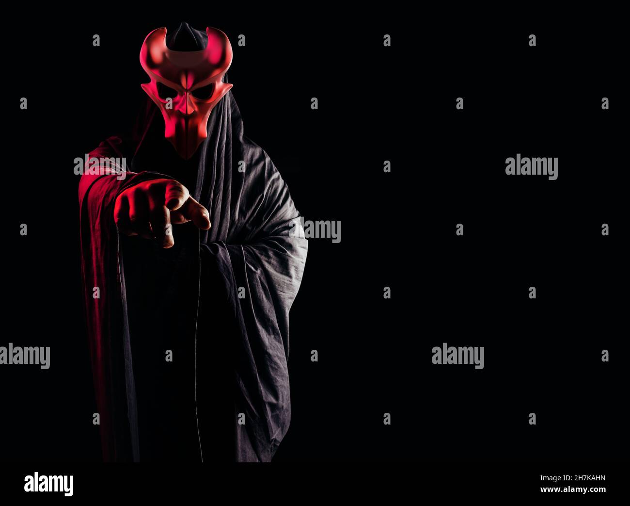 Scary horror occult sectarian priest in black hood and metal mask on ...