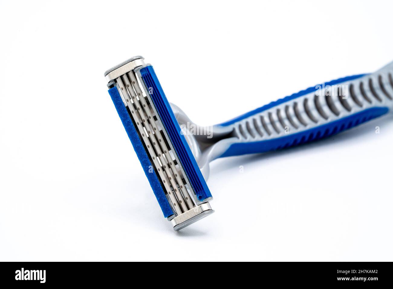 triple blade razor head in blue and gray colors on light background ...