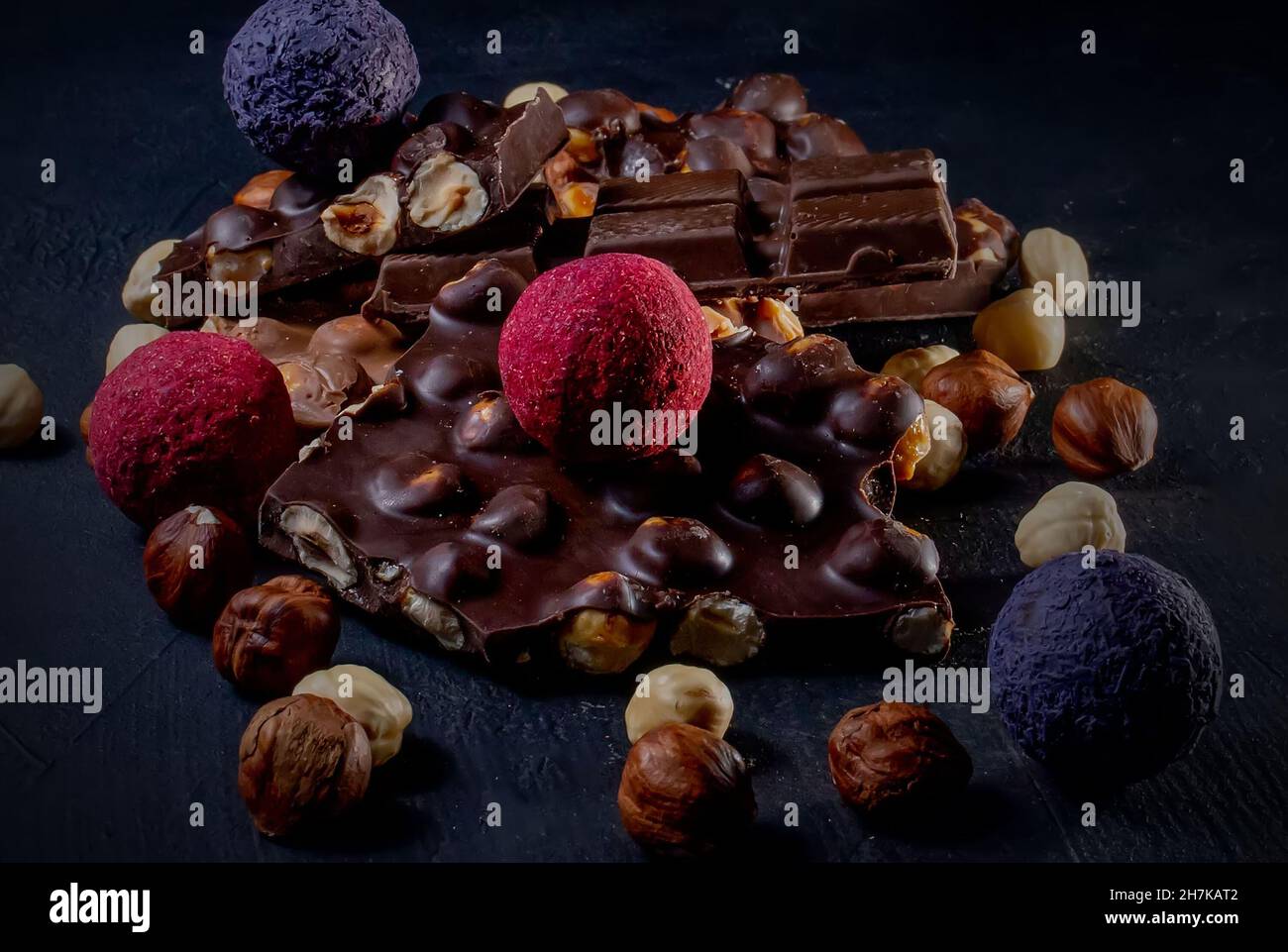 Chocolate bar, crushed pieces of dark chocolate and nuts. Praline ...