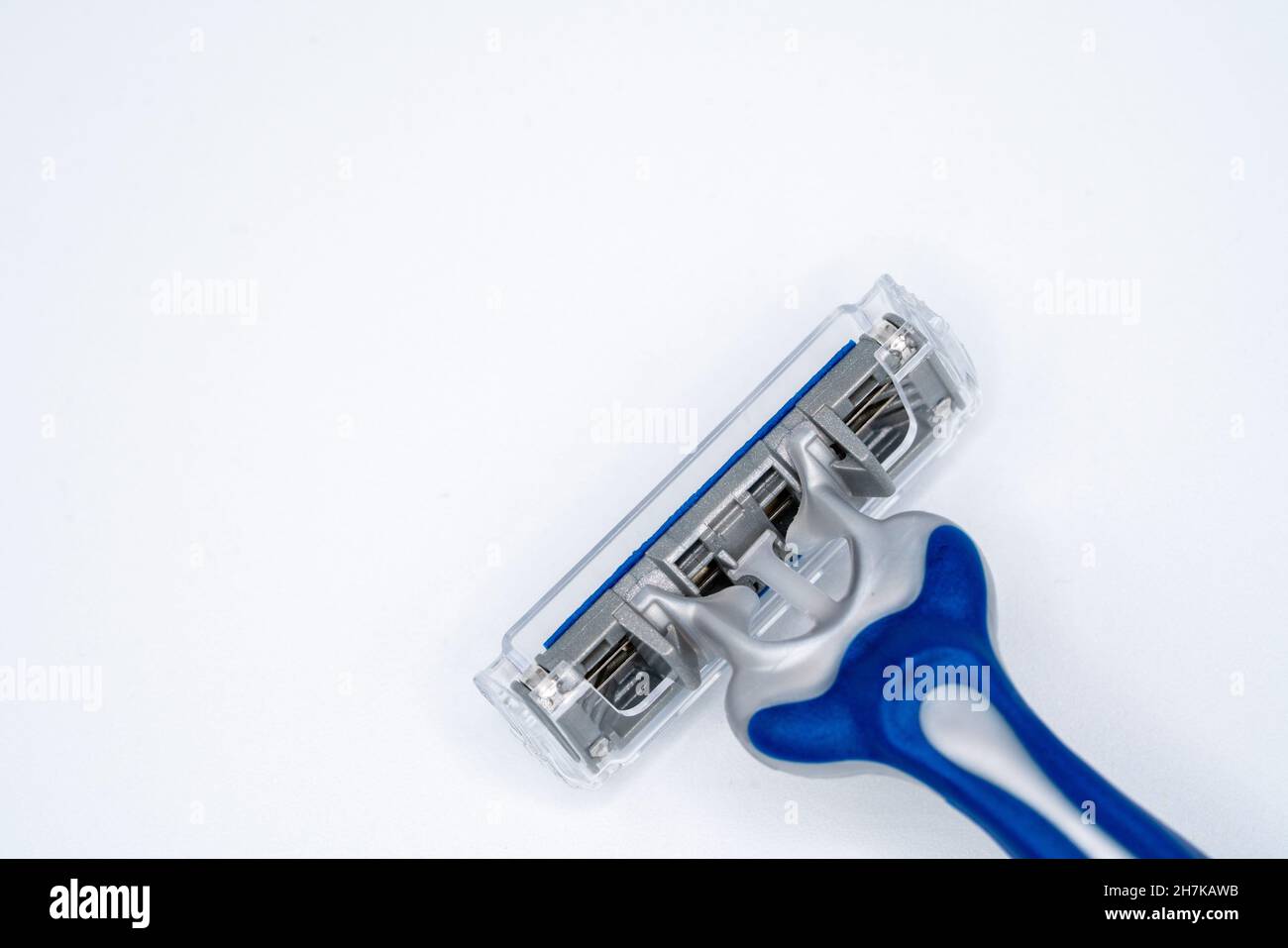 triple blade razor head in blue and gray colors on light background ...