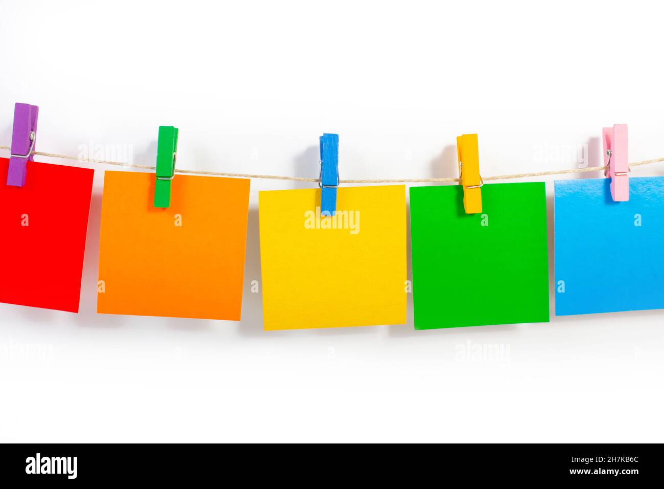 Photo of various paper notes hanging on rope with bee shaped pins on ...