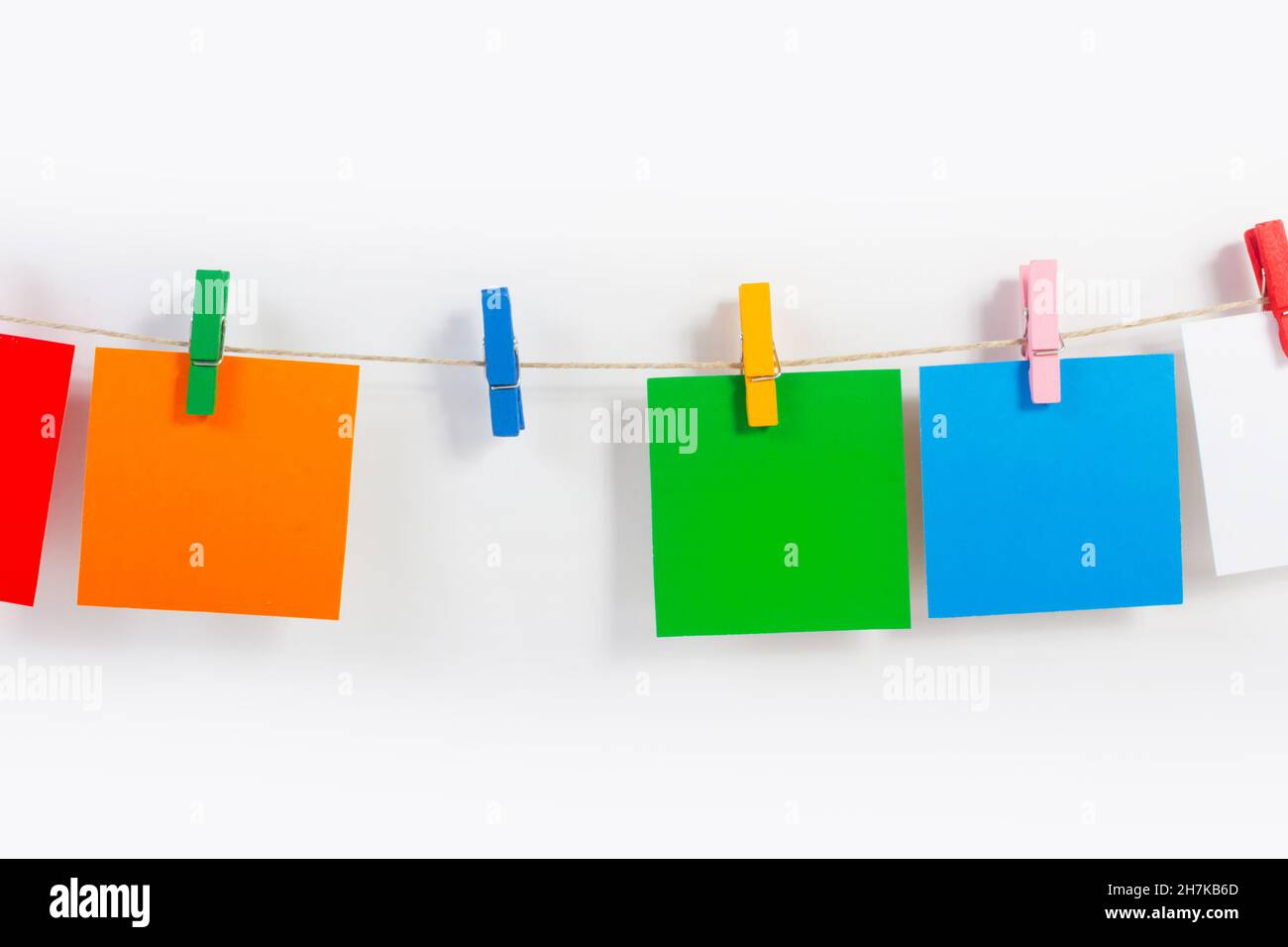 Photo of various paper notes hanging on rope with bee shaped pins on ...