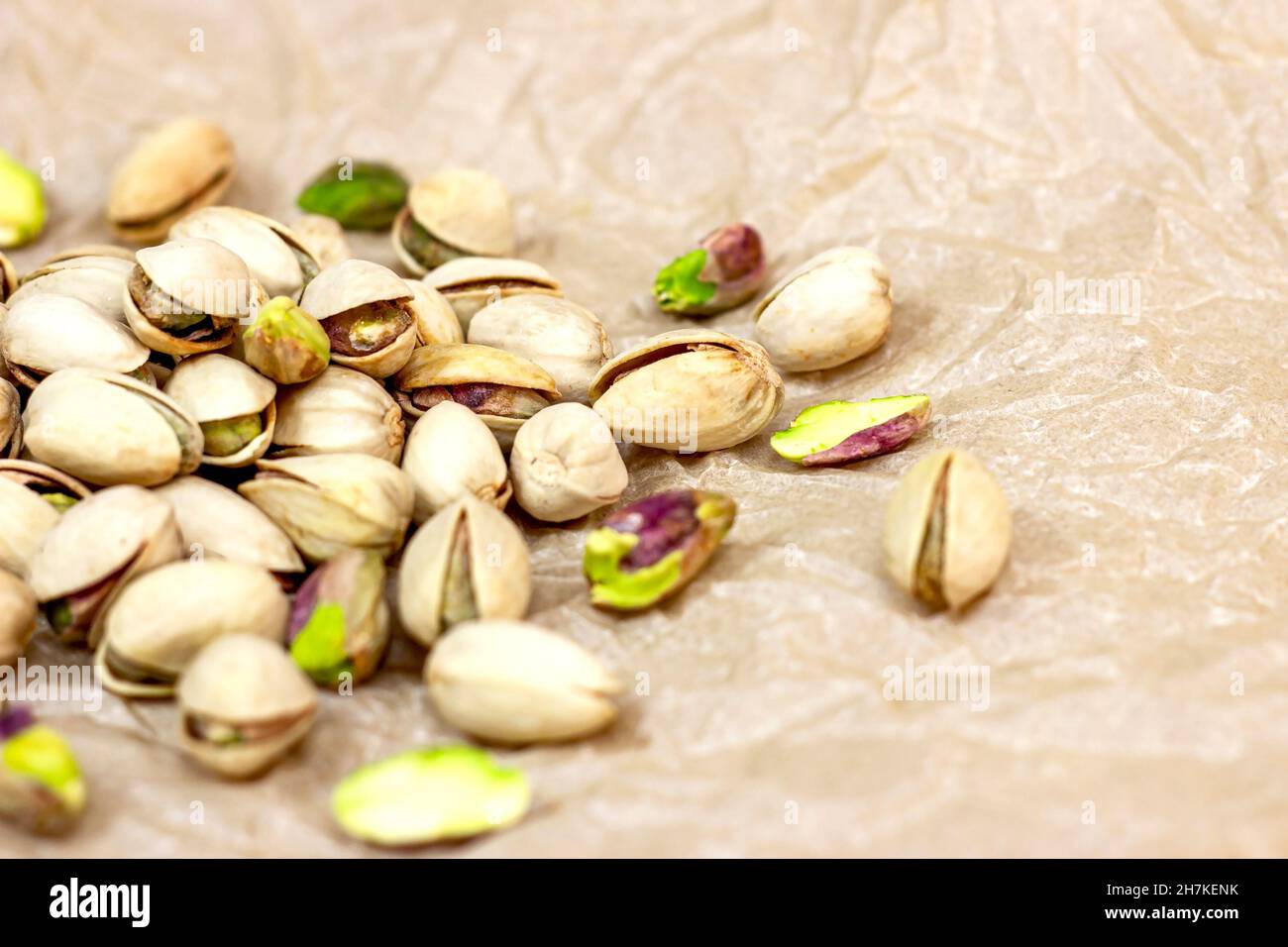Roasted salted pistachio nuts in nutshell on light background Stock Photo - Alamy