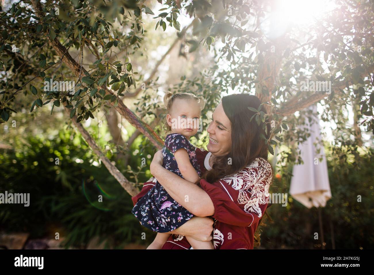 Mother & Daughter Standing Under Tree in California Stock Photo - Alamy