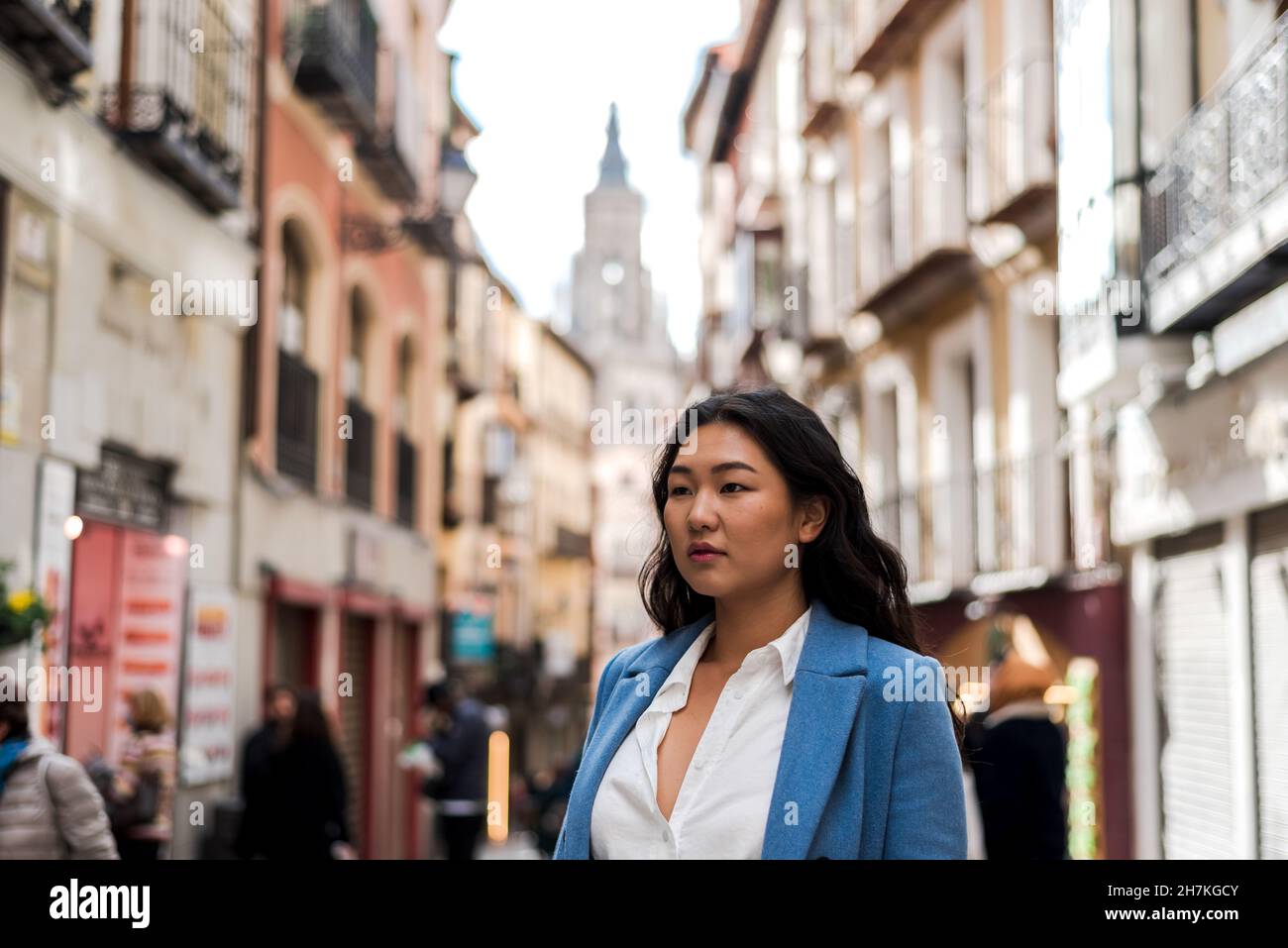 Elegant Asian woman walking down a historic street Stock Photo - Alamy