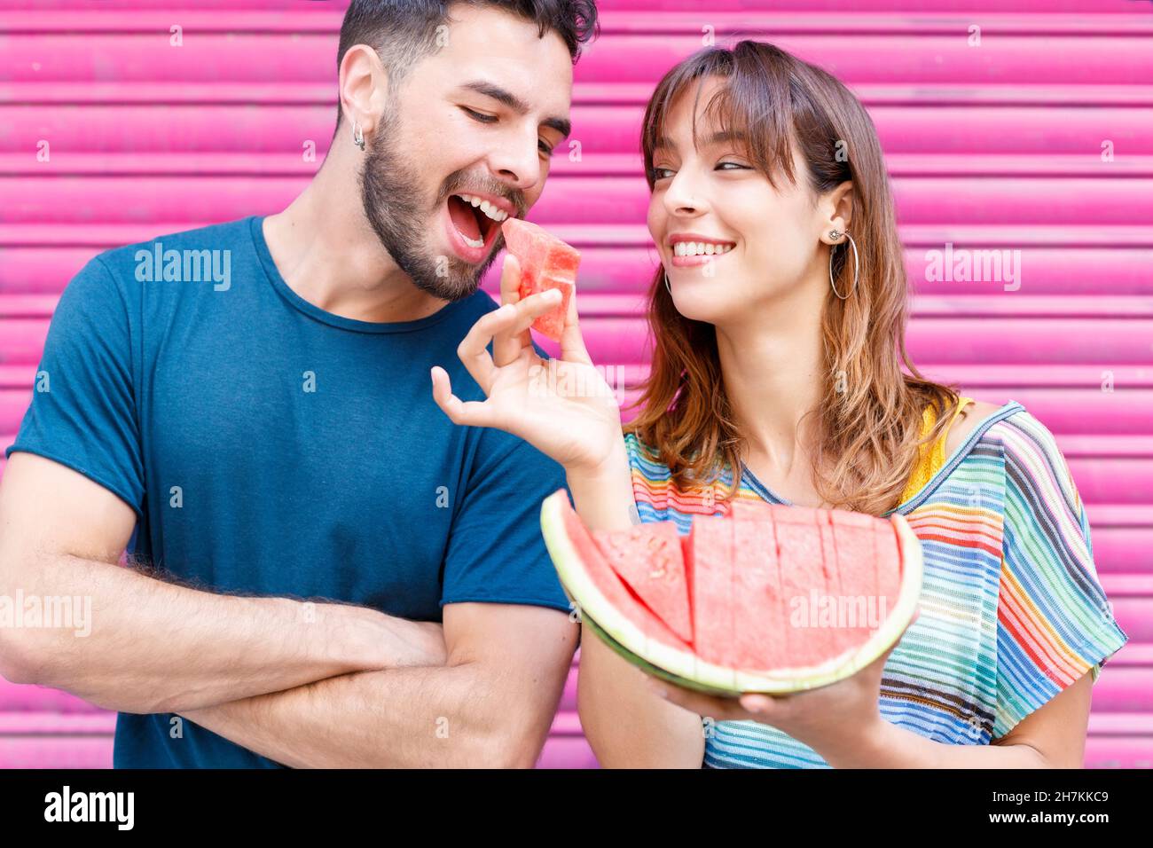 Man eating watermelon while woman screaming in background Stock Photo ...
