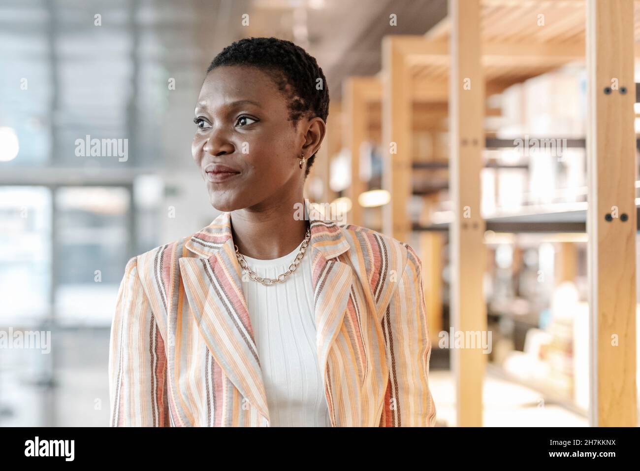 Smiling businesswoman having iced coffee while attending video call in ...