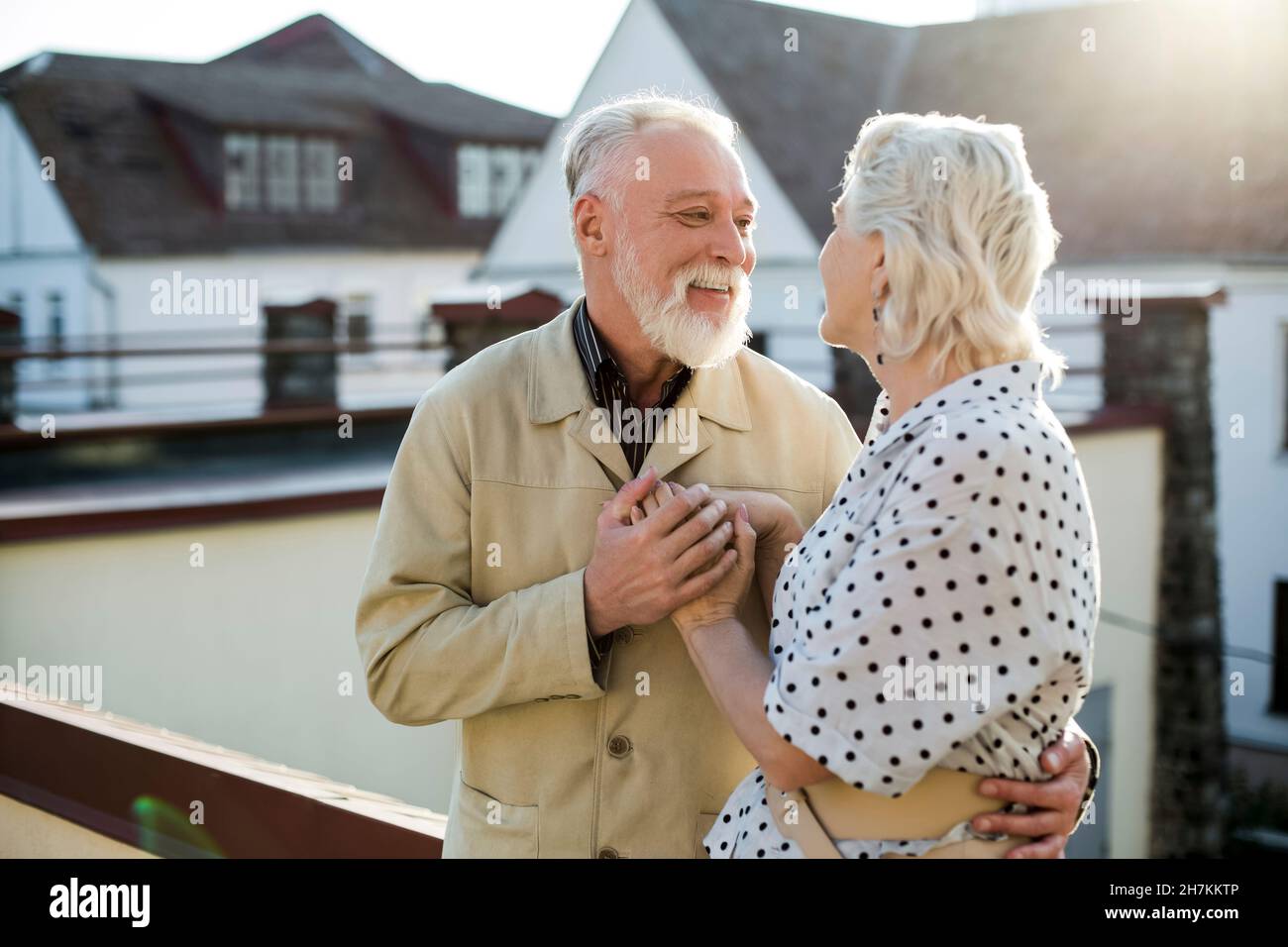 Smiling man looking at woman on rooftop Stock Photo - Alamy