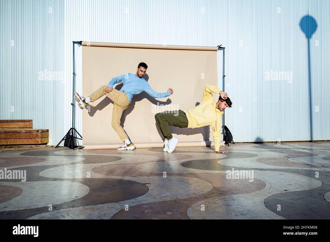 Male performers dancing near backdrop Stock Photo - Alamy
