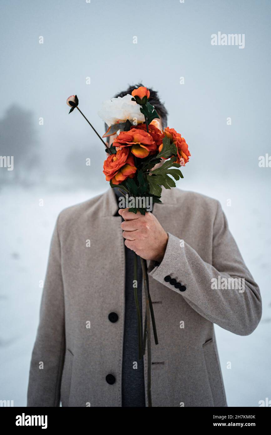 Man holding flowers covering face hi-res stock photography and images ...