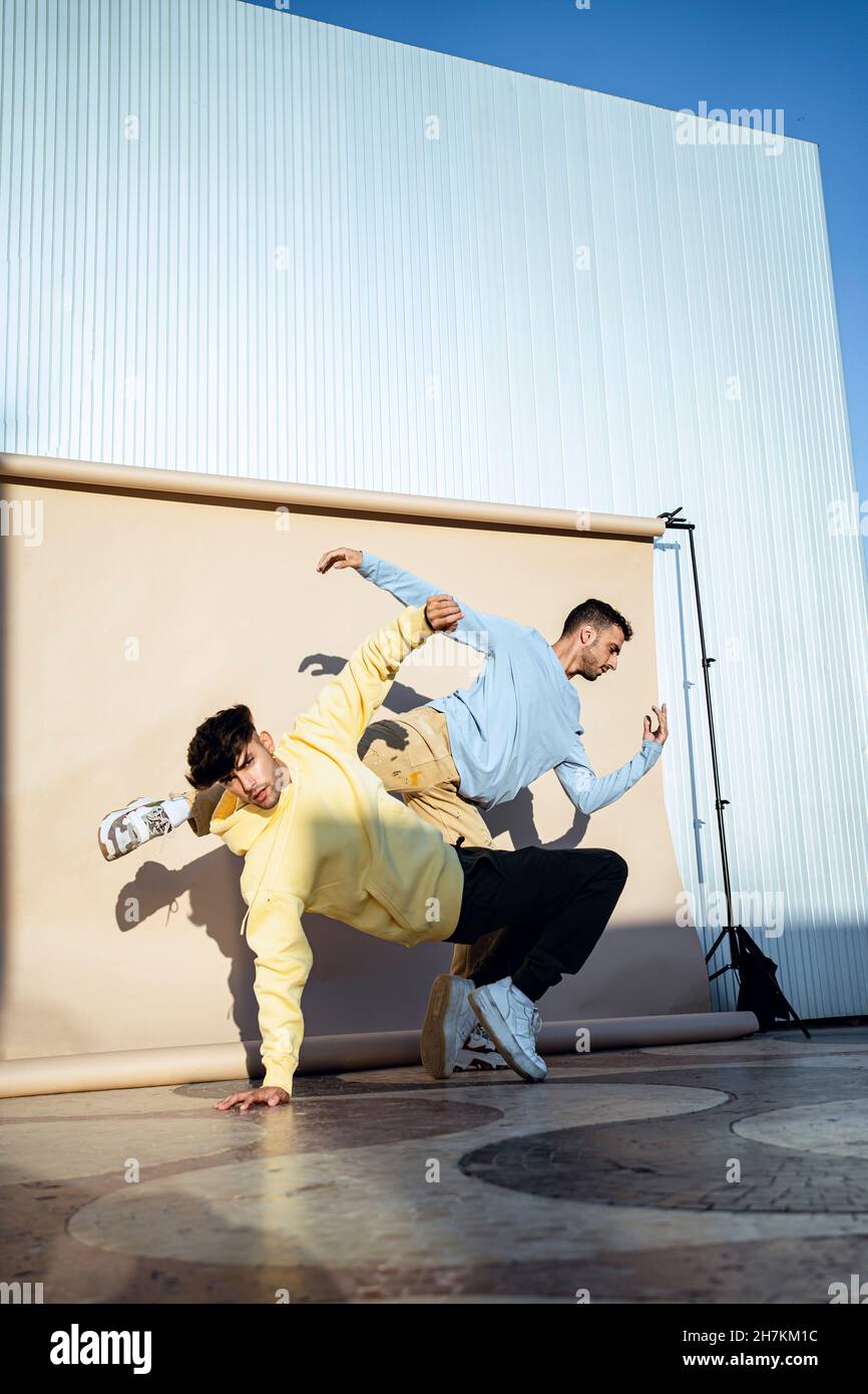 Male performers balancing while dancing near backdrop Stock Photo - Alamy