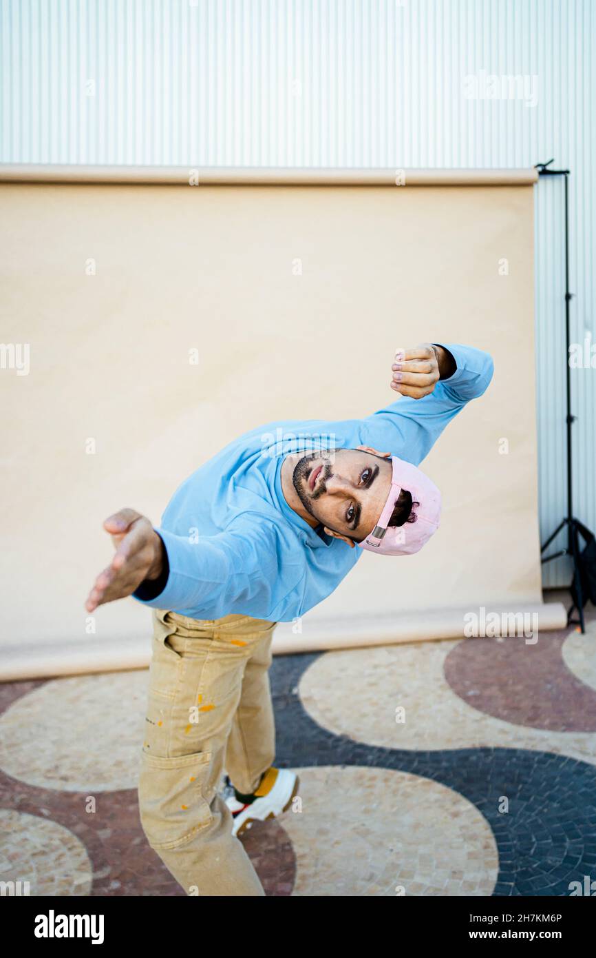 Mid adult man bending backwards while performing dance in front of ...