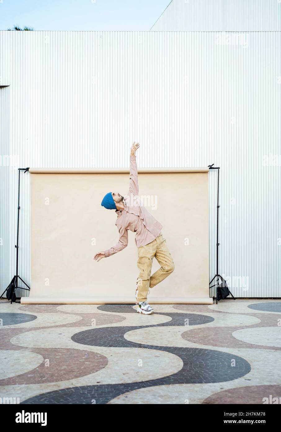 Mid adult dancer performing dance on floor by backdrop Stock Photo - Alamy