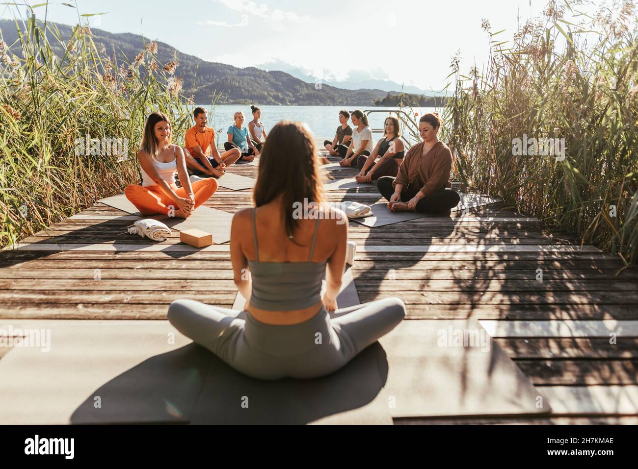 Female instructor teaching Baddha Konasana during yoga class Stock ...
