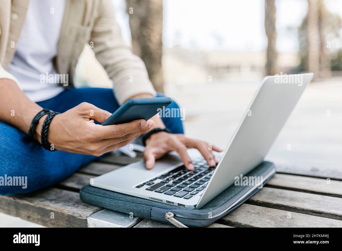 Using smart phone on urban bench hi-res stock photography and images ...