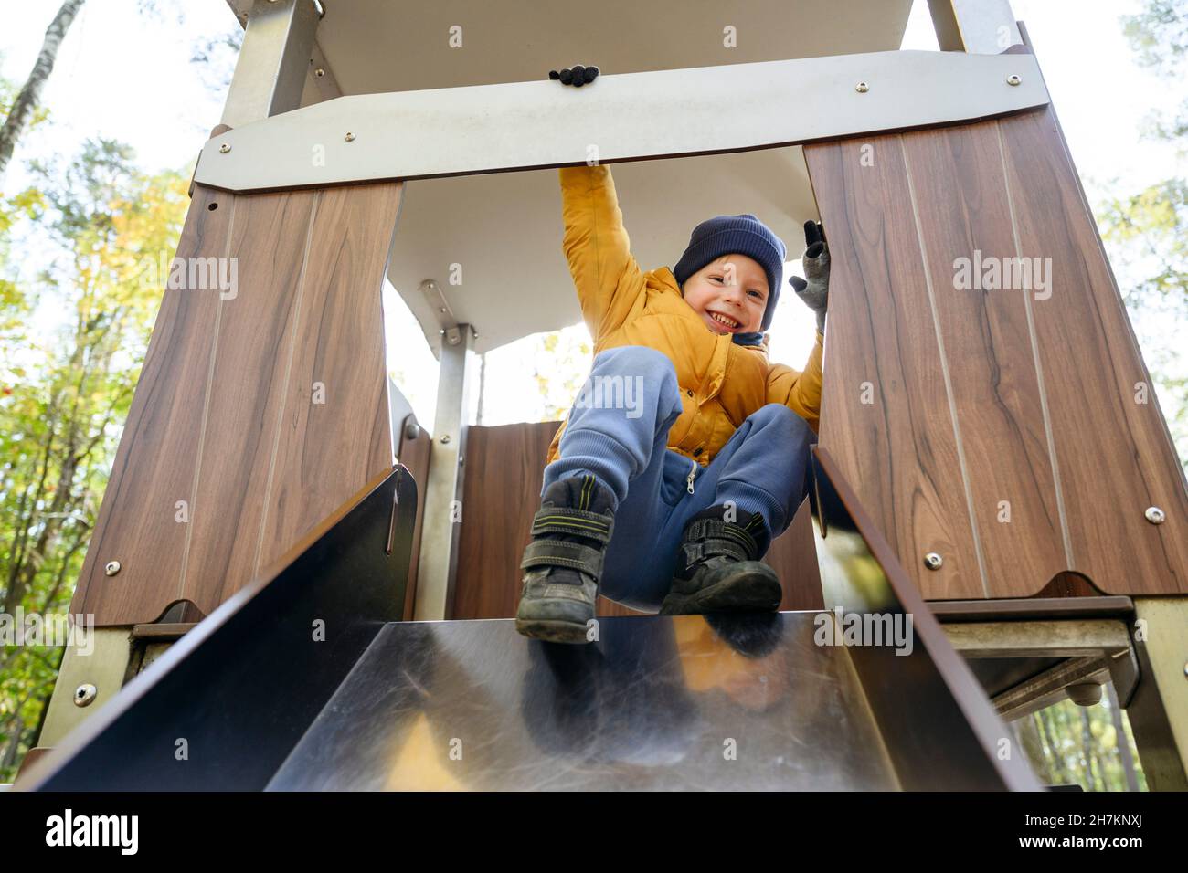 Man drinking iced coffee by son on bench Stock Photo - Alamy