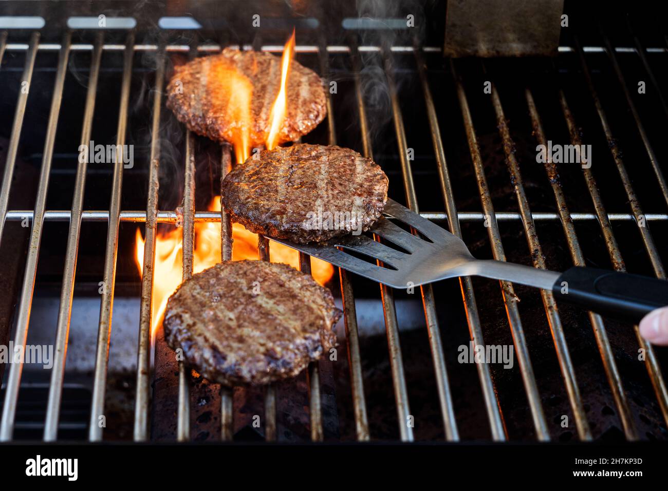 Burgers cooking on barbecue grill Stock Photo - Alamy