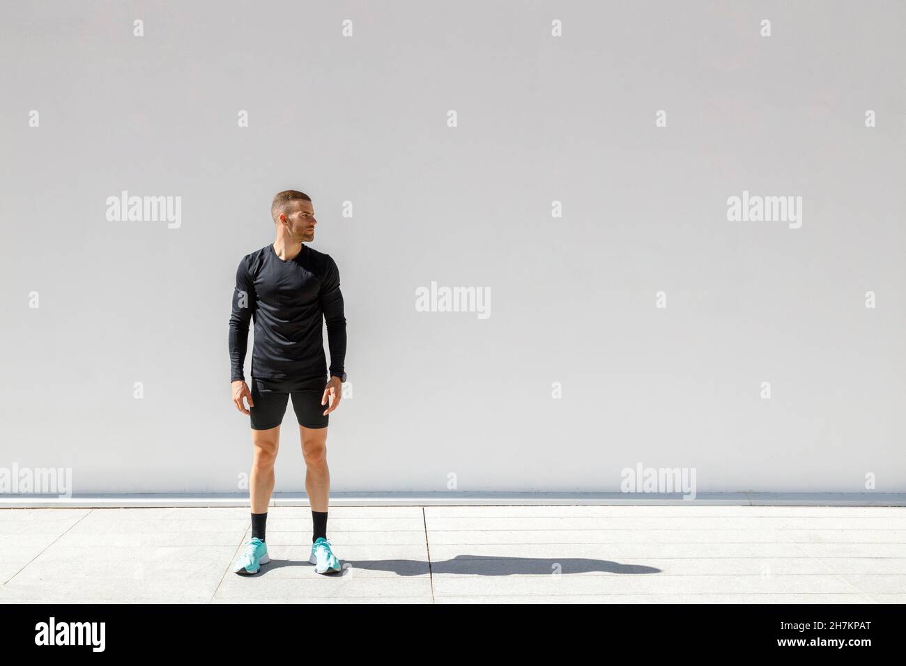 Fit male athlete running on footpath Stock Photo - Alamy