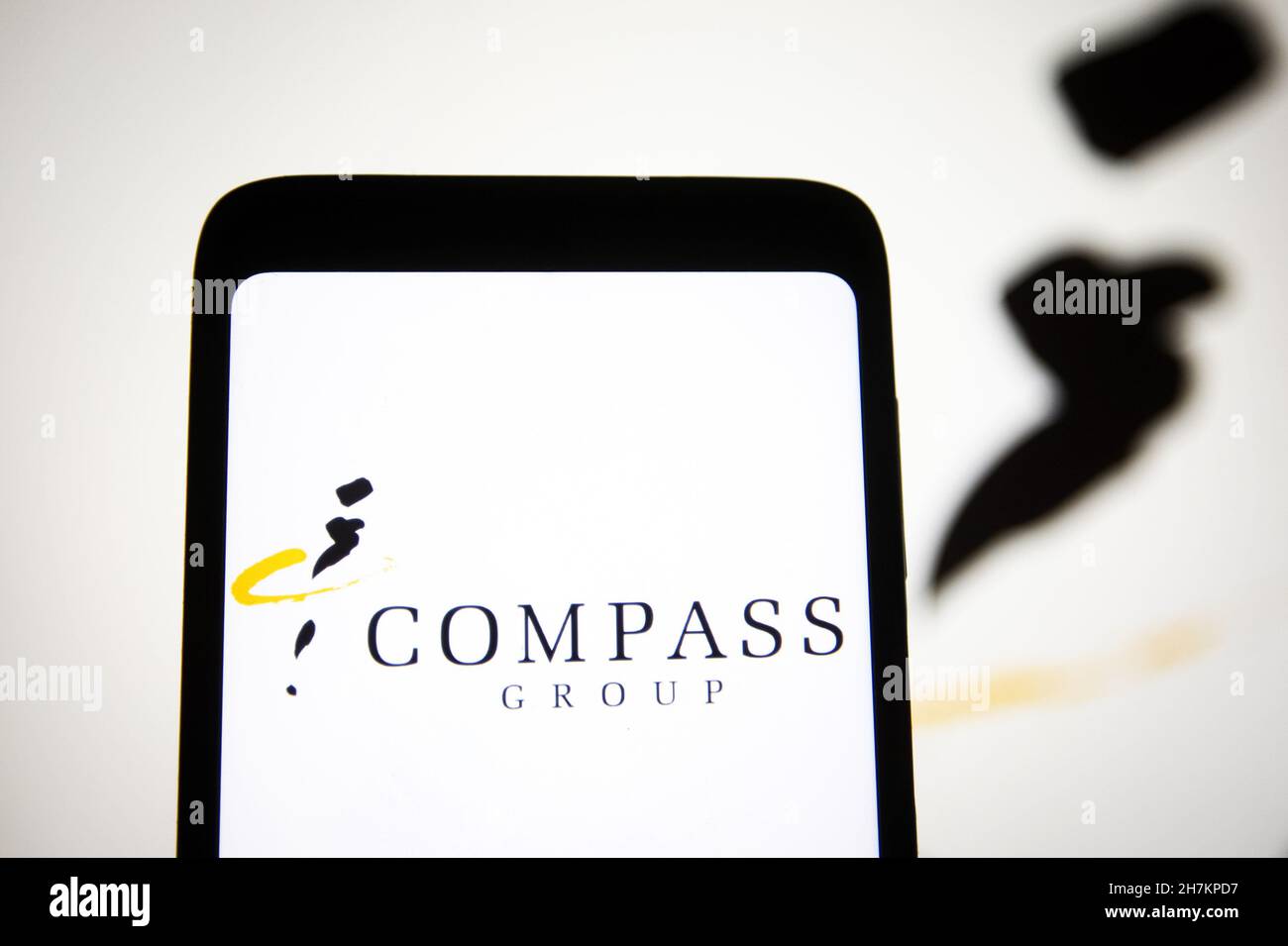 In this photo illustration, a Compass Group plc logo is seen on a ...