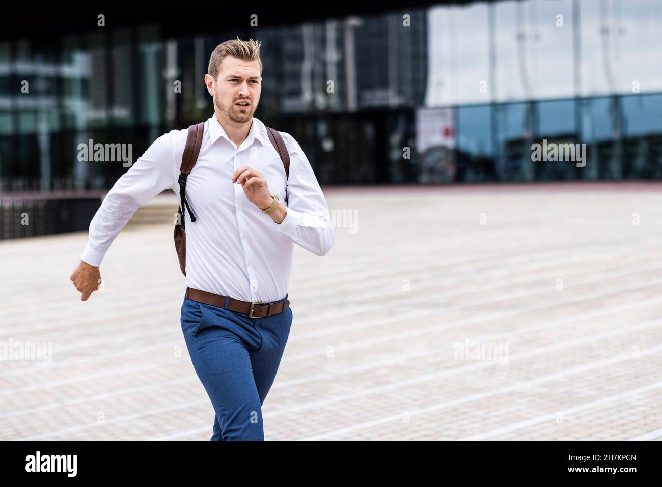 Young businessman with backpack running hi-res stock photography and ...