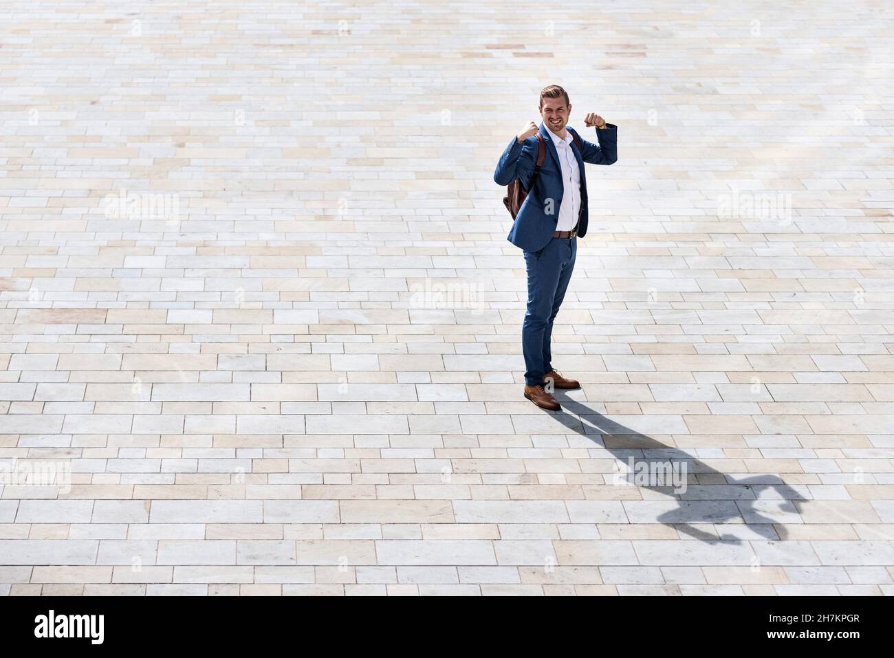 Young businessman flexing muscles on sunny day Stock Photo - Alamy