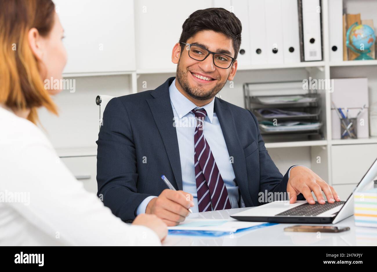 Businessman with female client Stock Photo - Alamy