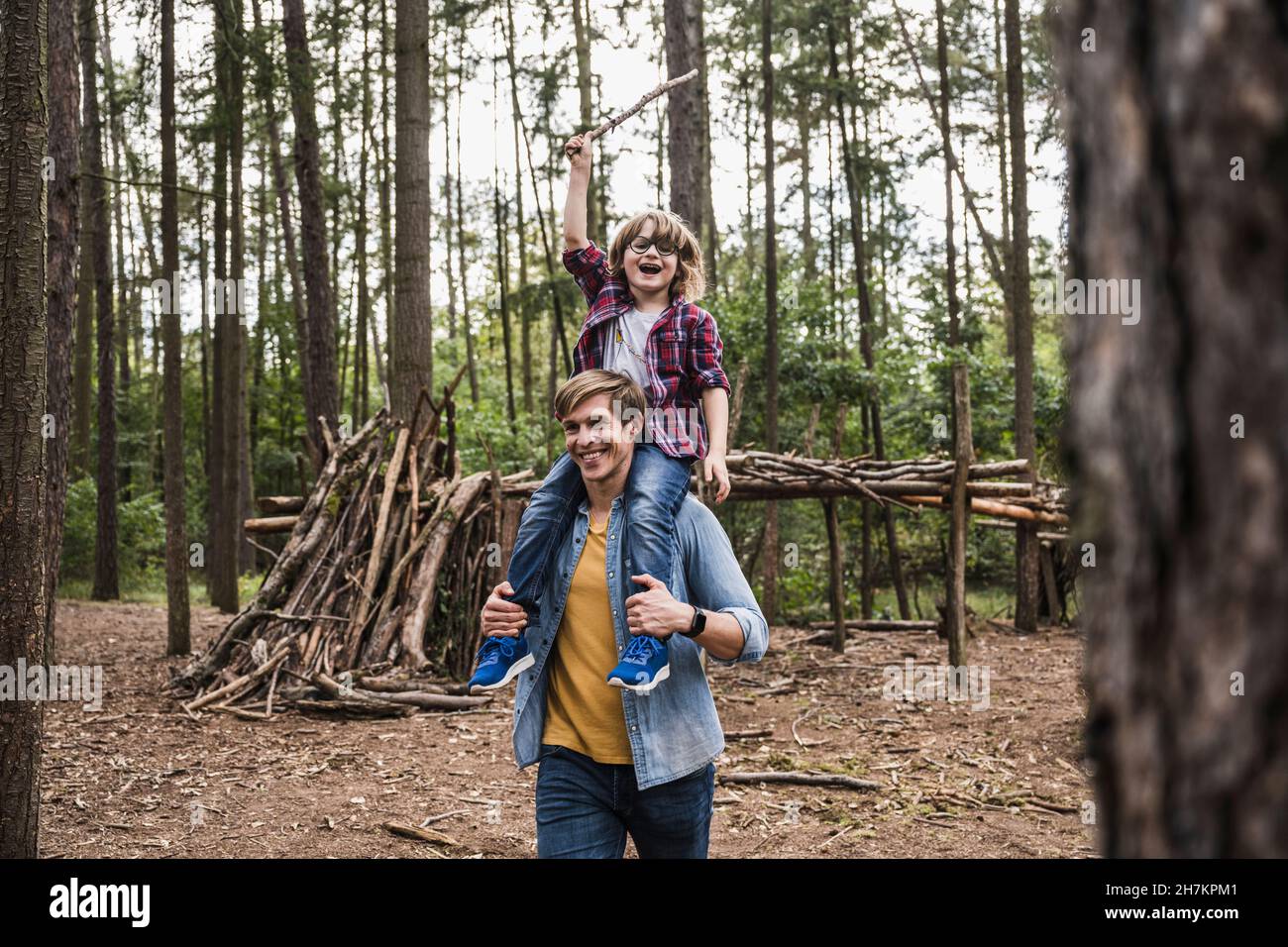 Happy father carrying son on shoulders in forest Stock Photo - Alamy