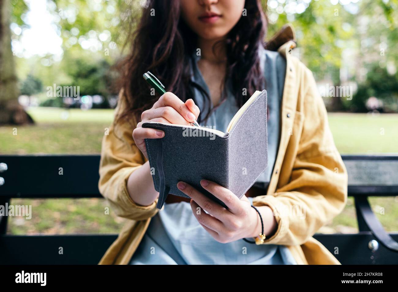 Women sitting park writing hi-res stock photography and images - Alamy