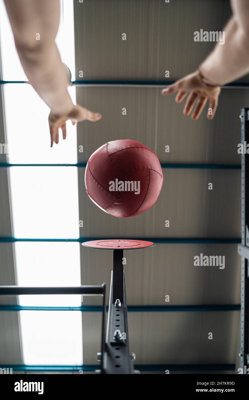 Athlete working out with sports ball in gym Stock Photo - Alamy