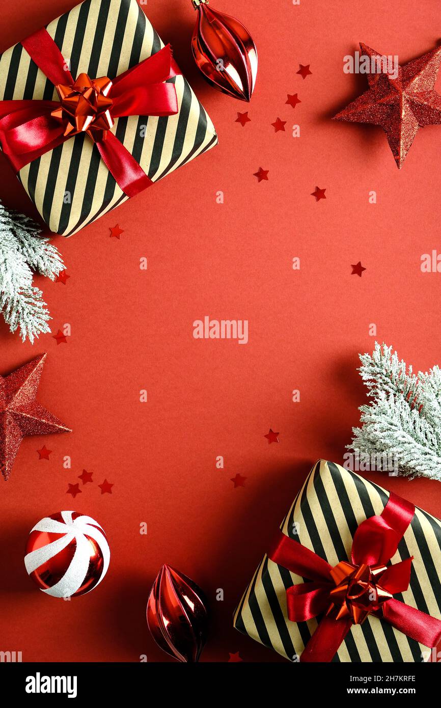 Red Christmas vertical background with Christmas gifts, vintage balls ...