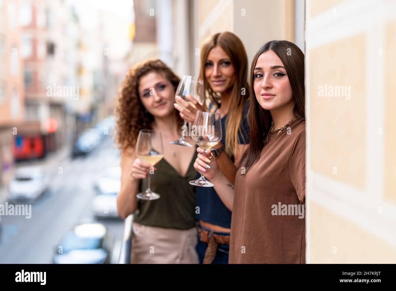 Friends standing on balcony hi-res stock photography and images - Alamy